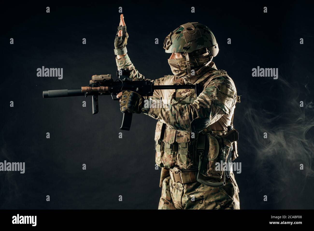 portrait of adult carrying out military service, soldier man with rifle ...