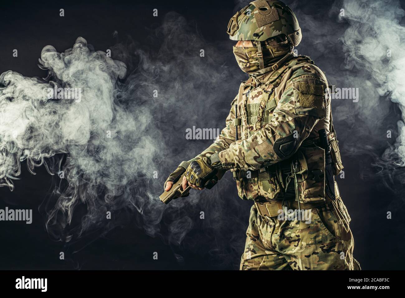 young man from military forces in green military wear try to shoot on ...
