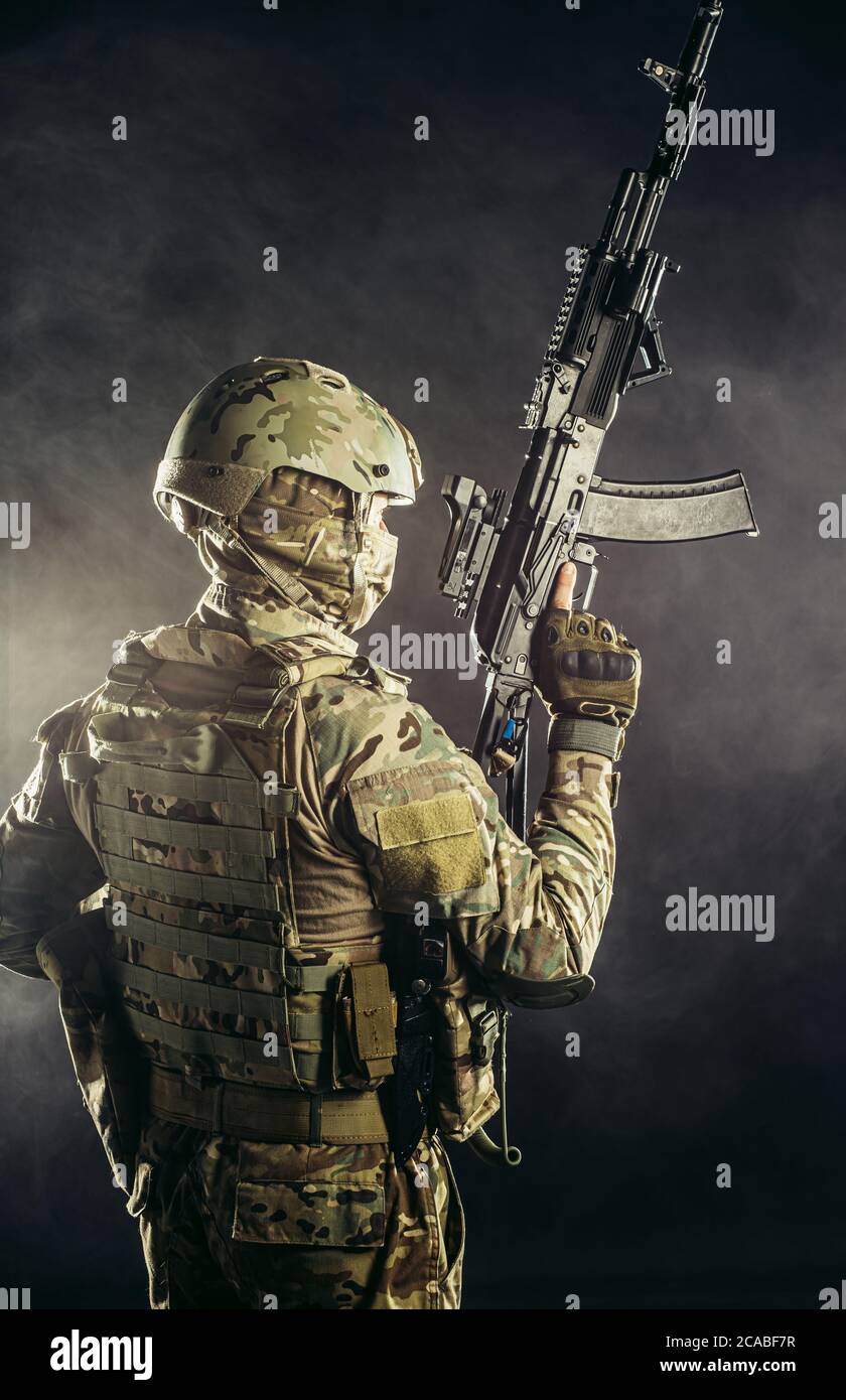 brave and strong soldier in military uniform holding rifle in hands ...