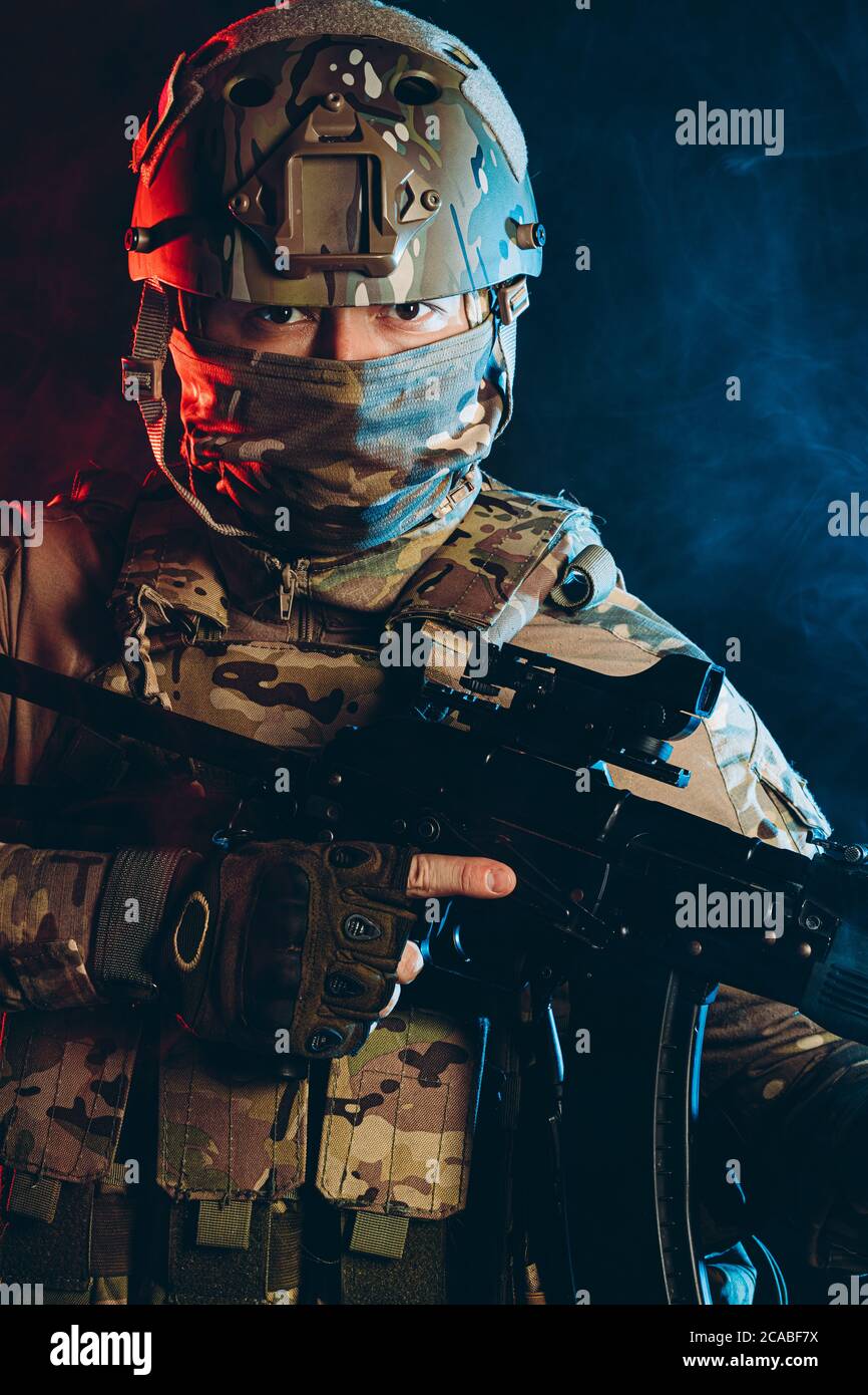 brave and strong soldier in military uniform holding rifle in hands ...