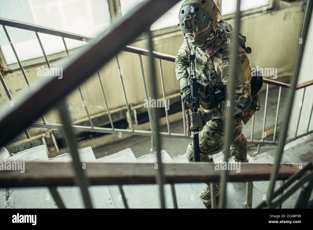 military forces concept. young soldier go to protect holding gun and ...