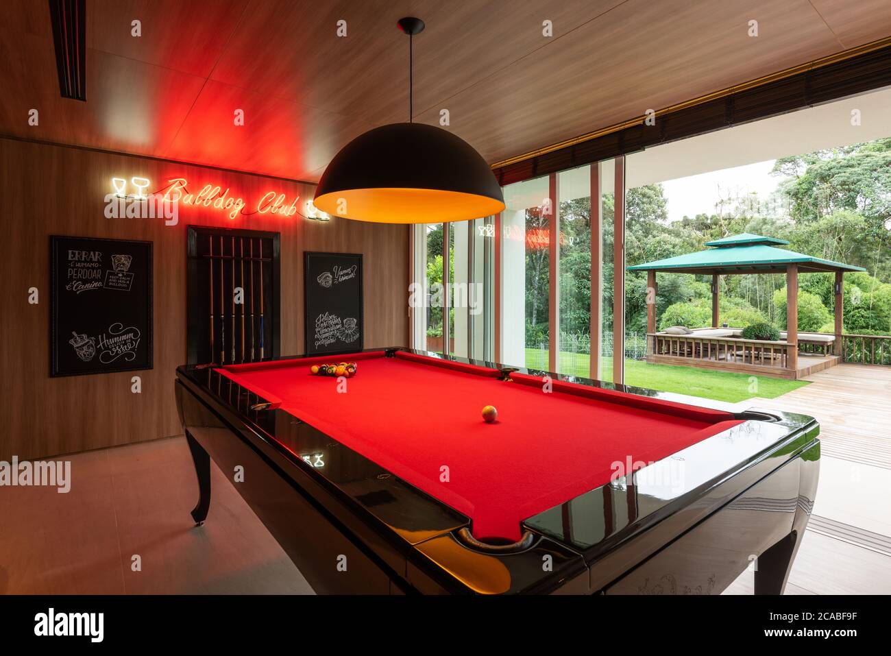 Red pool table on a playroom with big windows nature view, bulldog neon ...