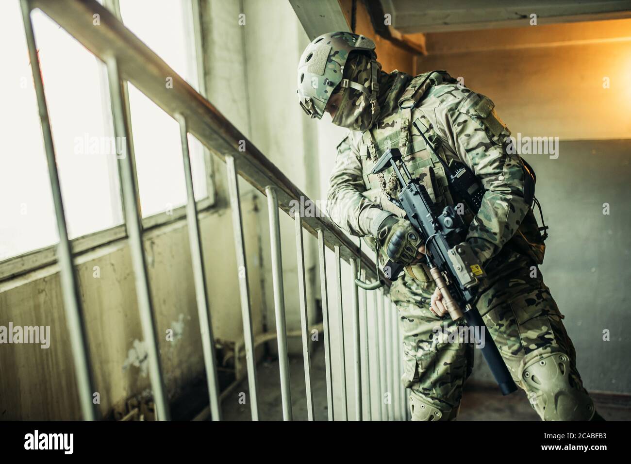 young soldier carrying out military service, in readiness at work, in ...