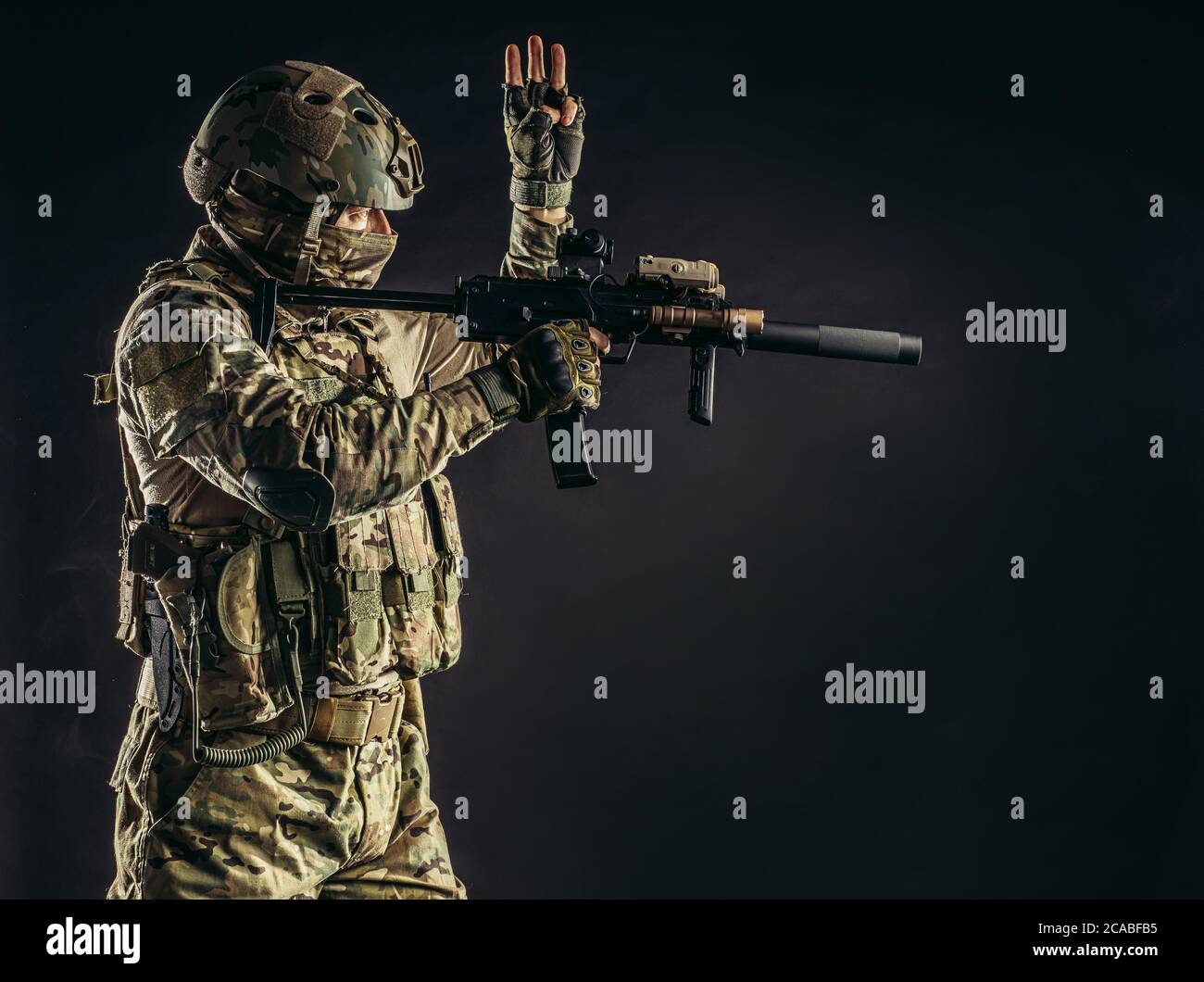 side view on military man counting, expect shooting from weapon ...