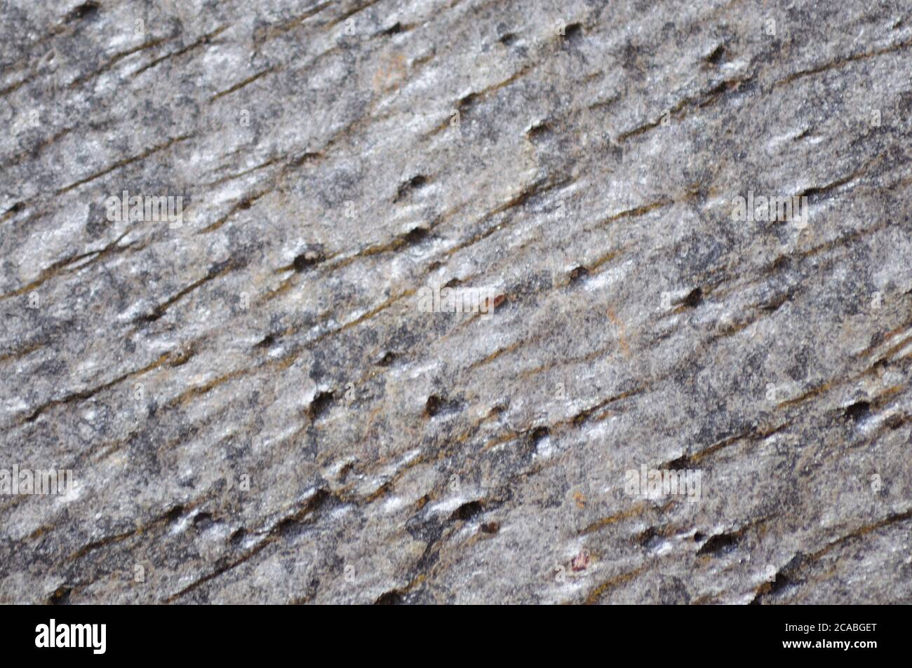 Rough surface of natural gray stone with traces of rough processing ...