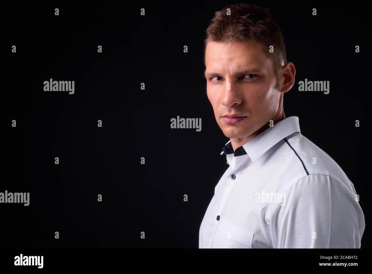 Man looking over shoulder serious hi-res stock photography and images ...