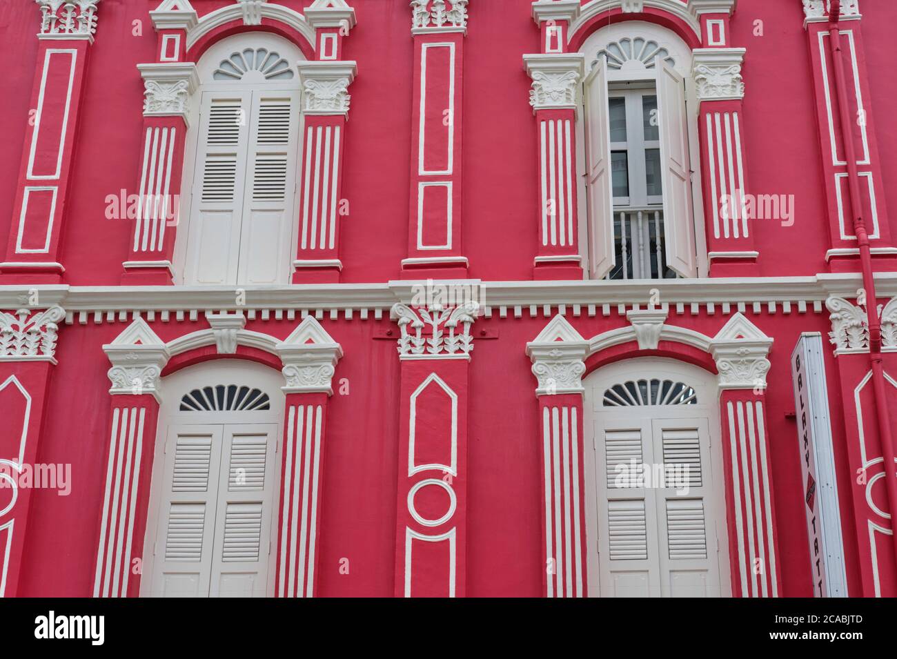 A beautifully restored red-pink traditional-style Chinese house with ...