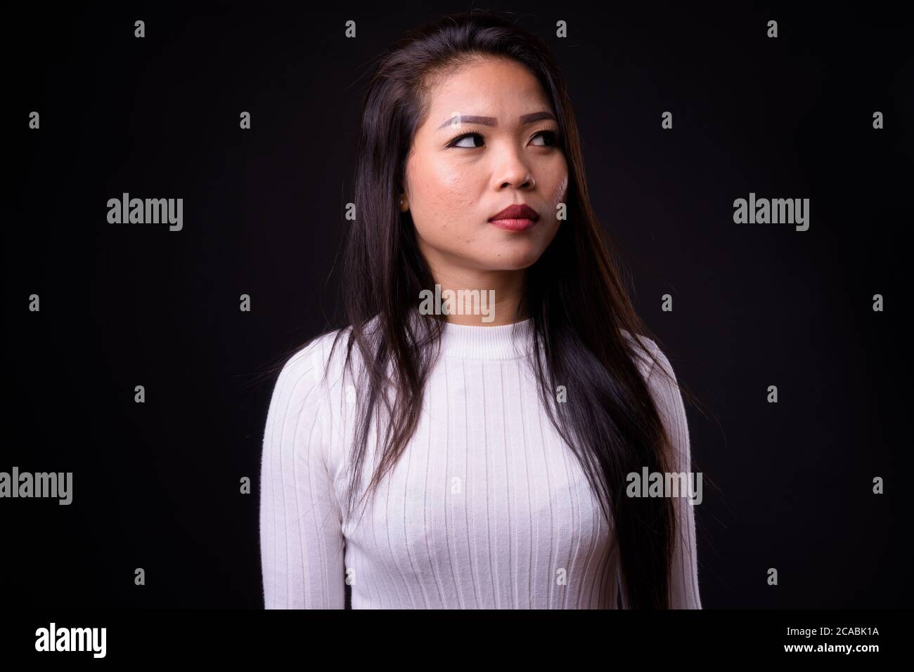 Portrait Of Young Beautiful Asian Woman Against Black Background Stock