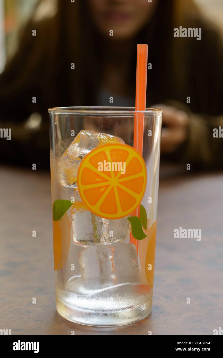 Portrait of glass with ice and straw Stock Photo - Alamy