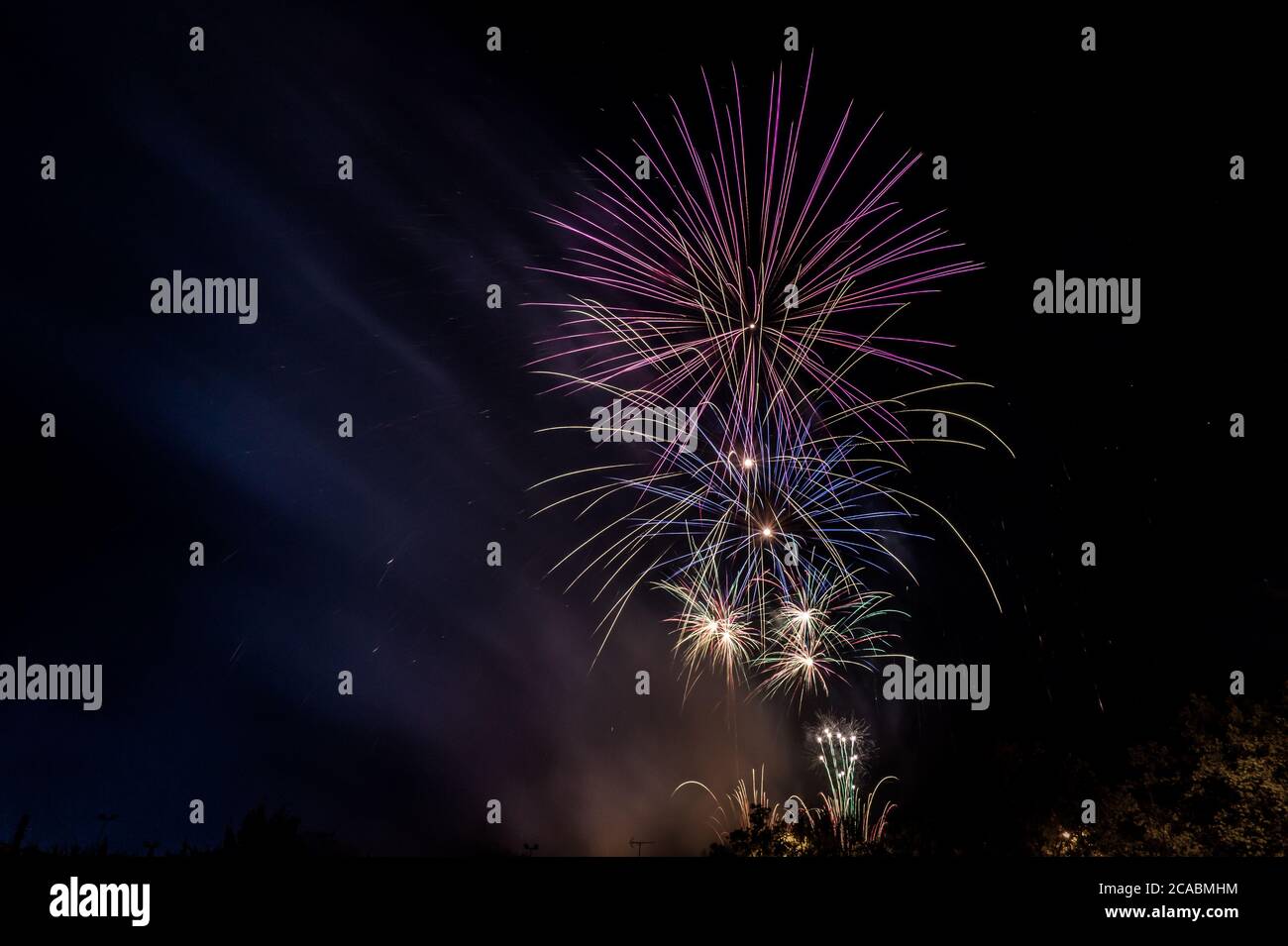 Low angle shot of the colorful fireworks in the night sky above the ...