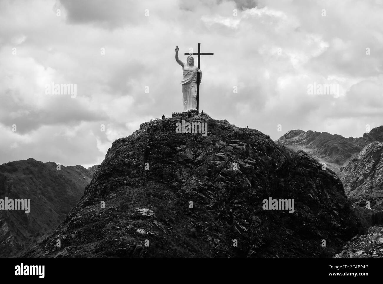 Grayscale shot of the statue of Jesus Christ holding the cross ...