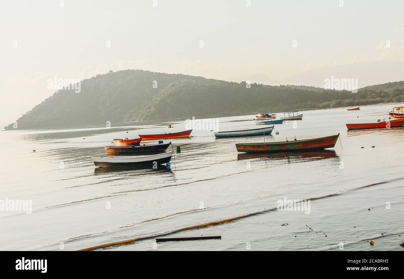 Beautiful view of fishing boats in the sea with a mountain on the ...