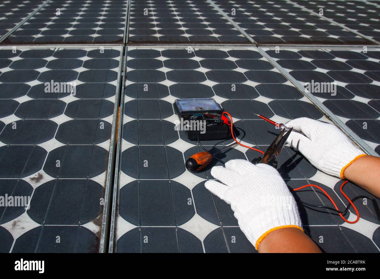 Technician repairing photovoltaic modules (Solar panels) in rural Stock ...