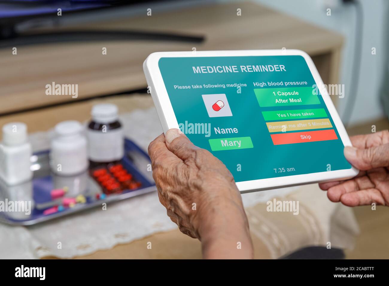 Senior adult use medical reminder app to help keep her safe and in ...