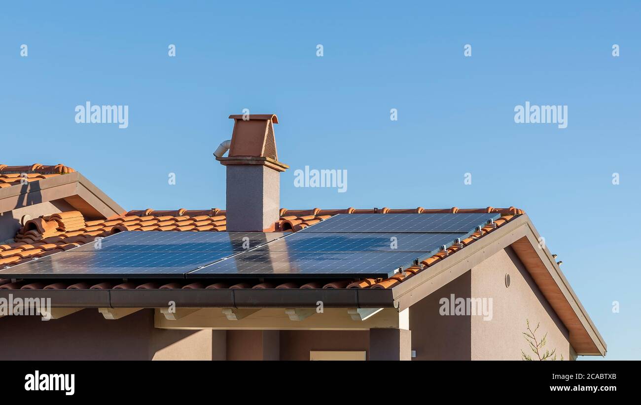 Solar panels for the production of clean energy on a roof with red ...