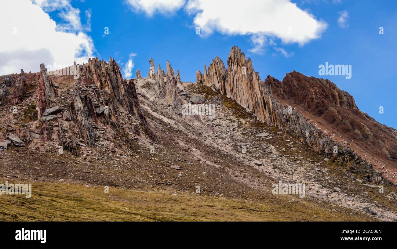 Sharp and jagged rock pillars on a mountain in Cusco, Peru under a ...
