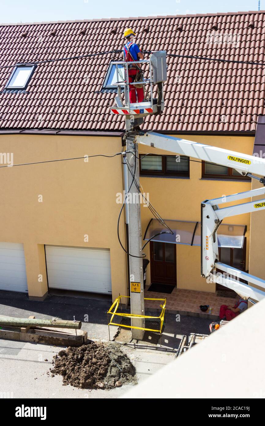 Process of installing new concrete electricity pylon in the street ...