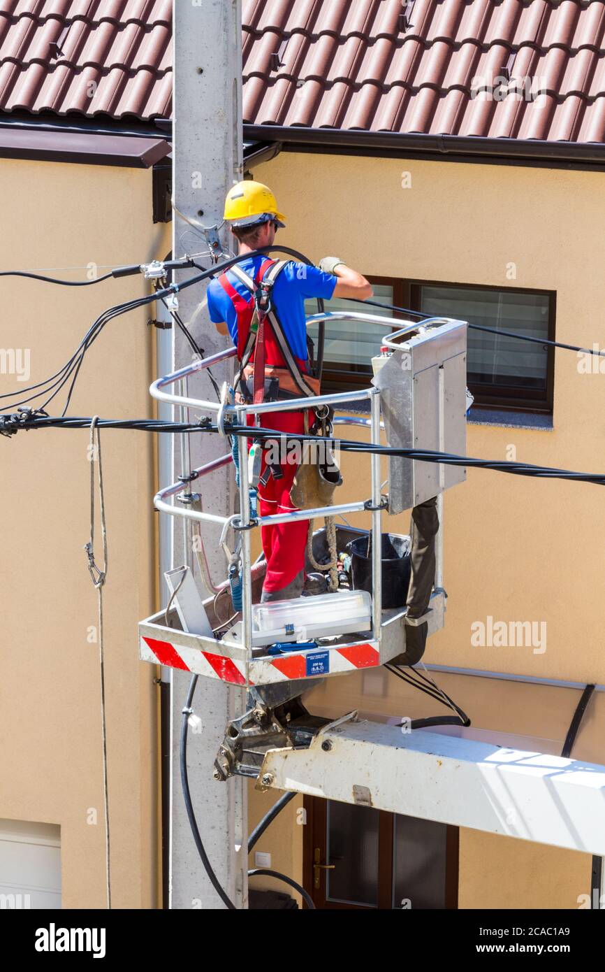 Process of installing new concrete electricity pylon in the street ...