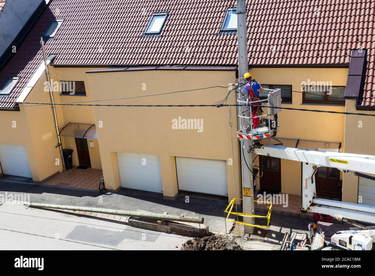 Process of installing new concrete electricity pylon in the street ...