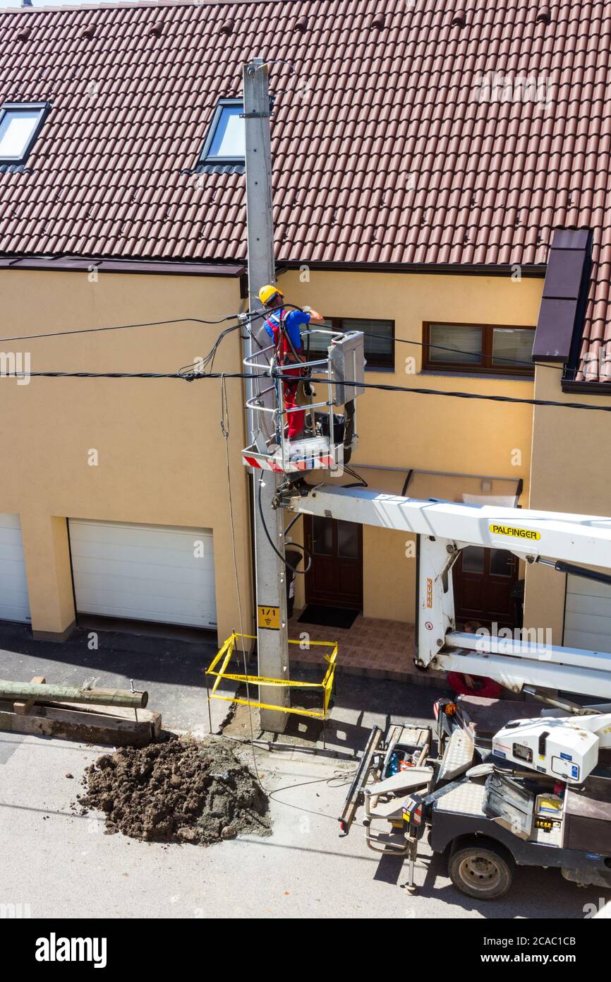 Process of installing new concrete electricity pylon in the street ...