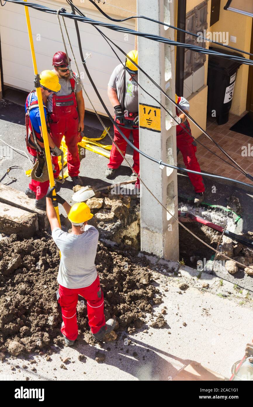 Process of installing new concrete electricity pylon in the street ...