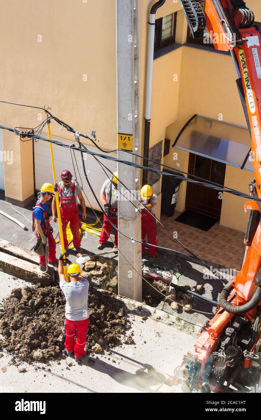 Process of installing new concrete electricity pylon in the street ...