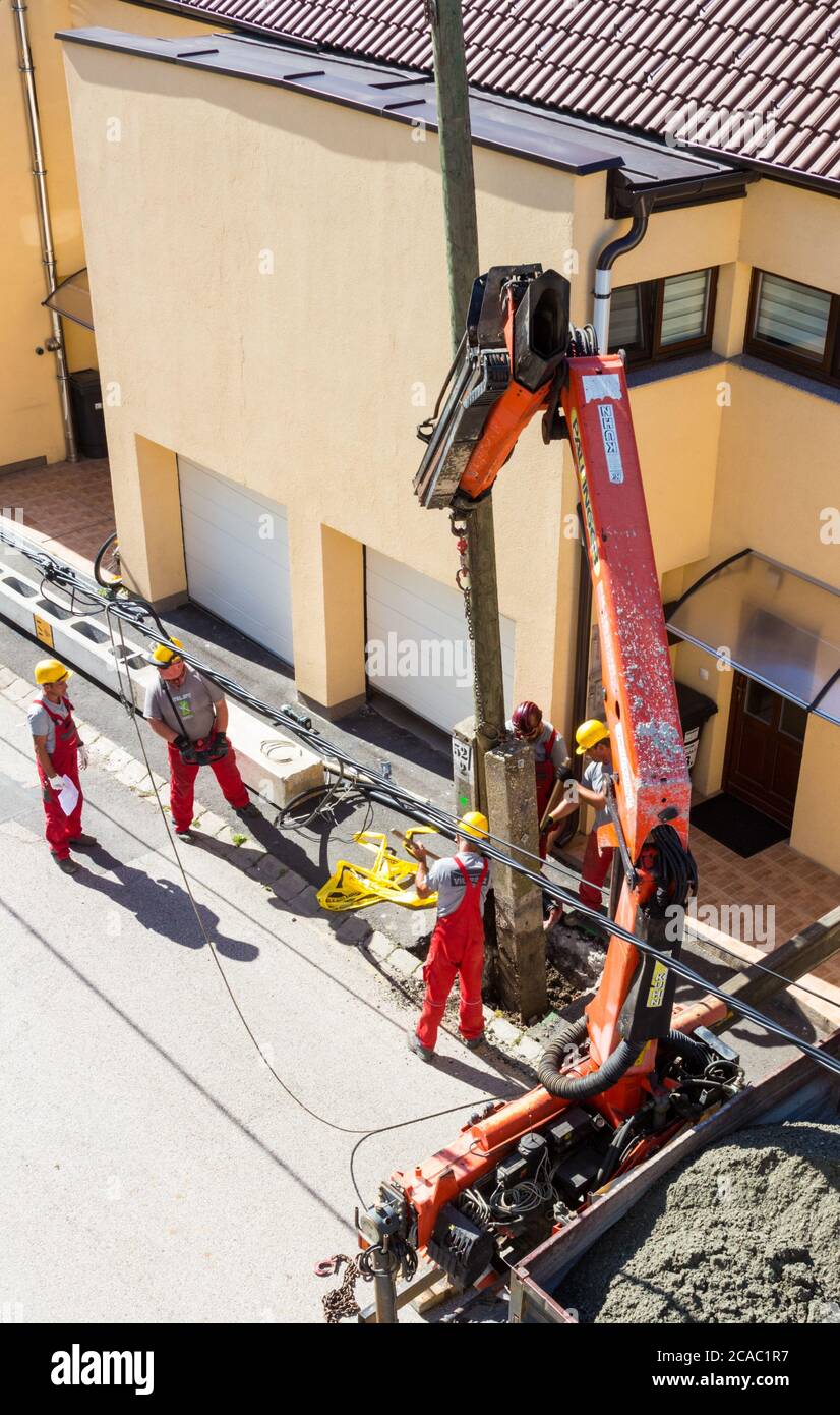 Process of installing new concrete electricity pylon in the street ...