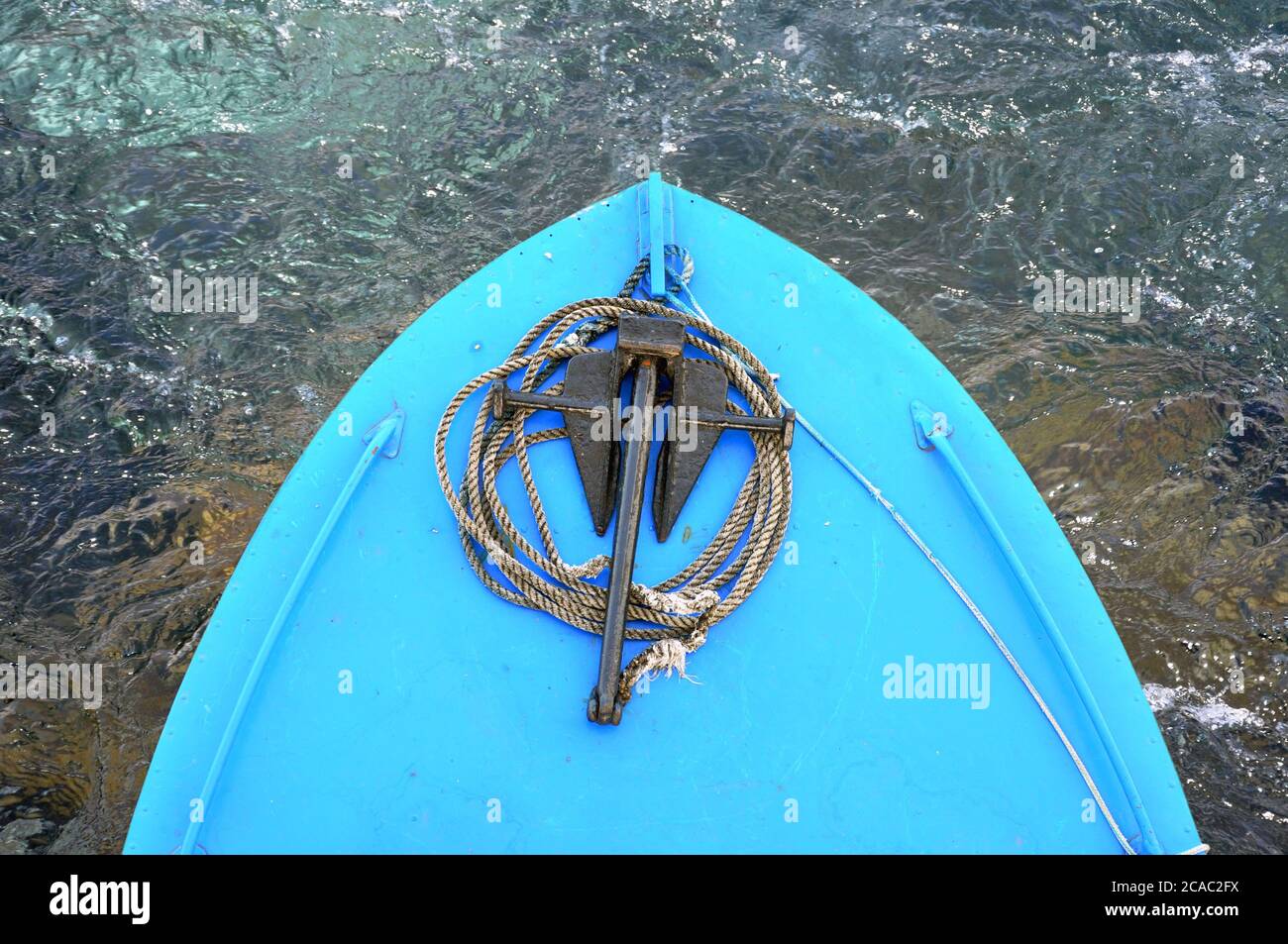 The bow of a boat floating on water with an anchor close-up Stock Photo ...