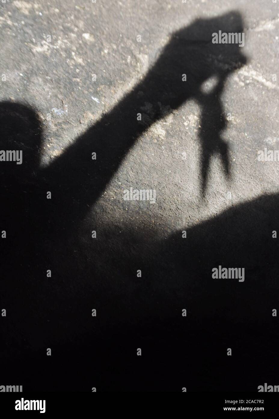 Vertical shot of a shadow of a hand holding scissors on a wall Stock ...