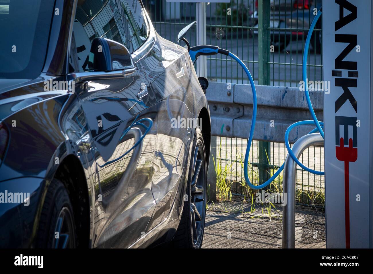 electric car at a charging station, focus on back of the car Stock ...