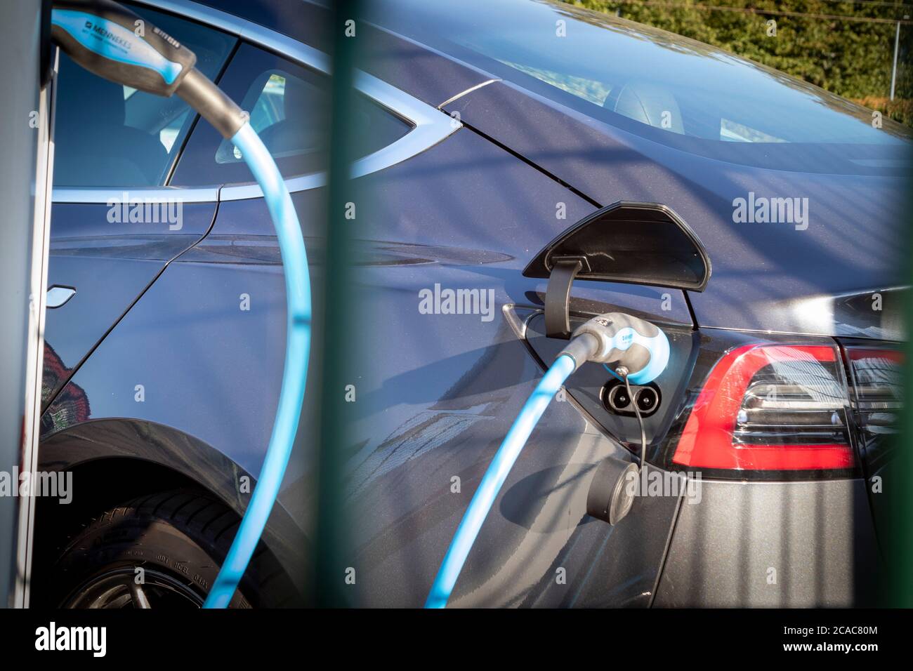 electric car at a charging station, focus on back of the car Stock ...