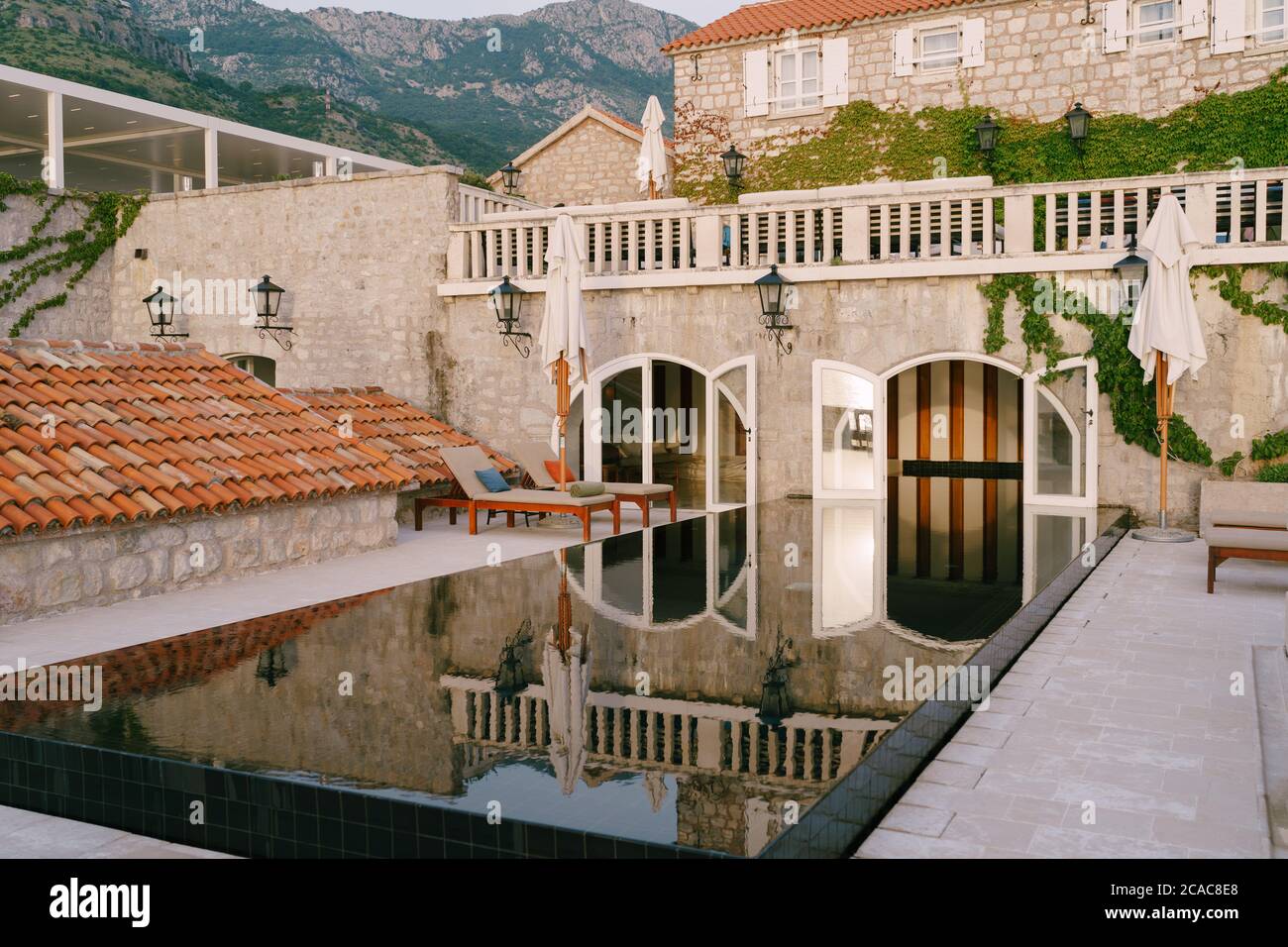 Mirror reflection in the swimming pool in the old villa Stock Photo - Alamy