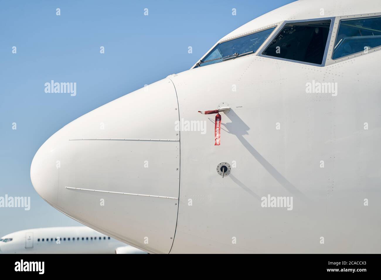 Nose of an airplane against the blue sky Stock Photo - Alamy