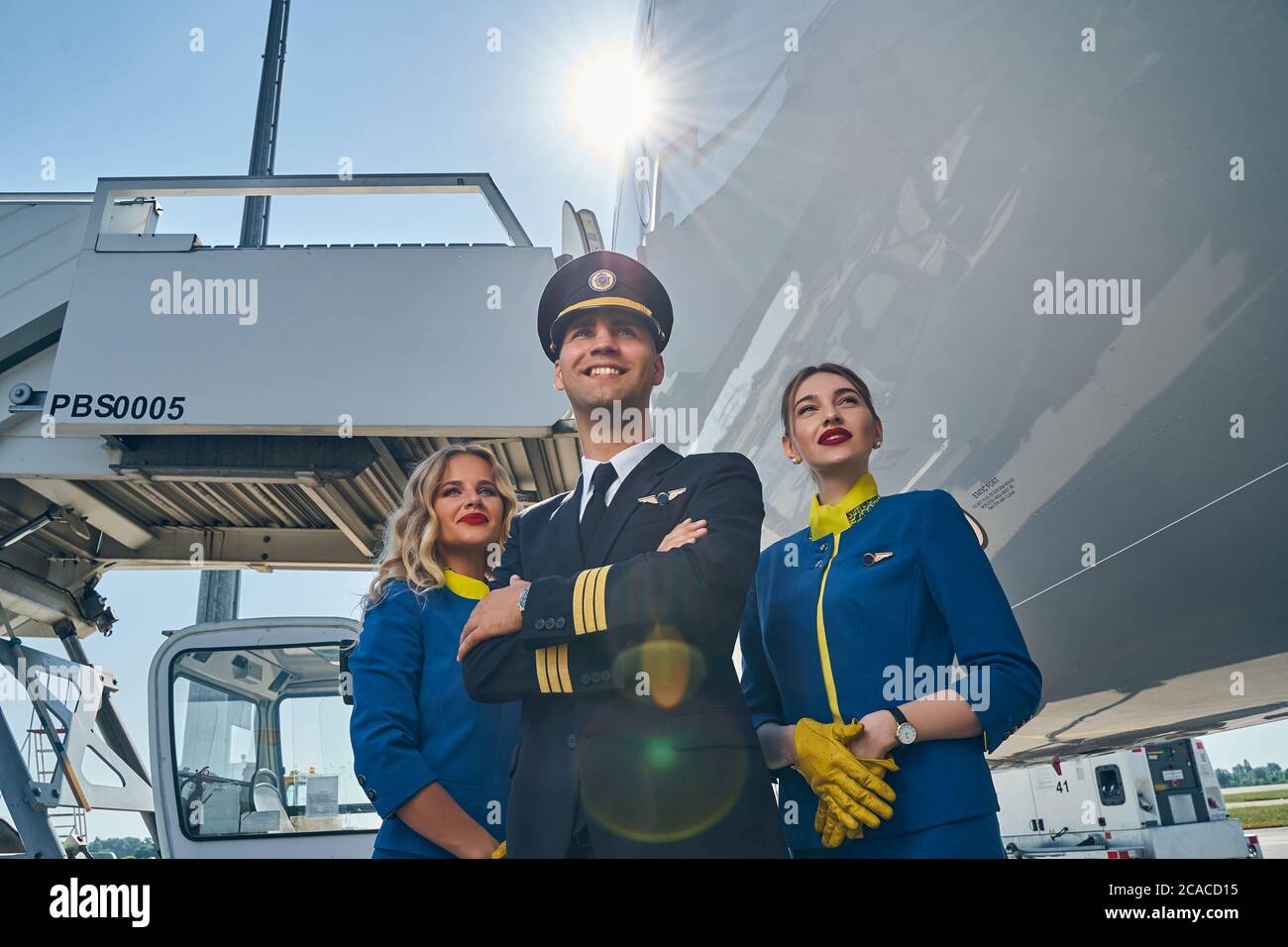 Smiling pilot flight attendant hi-res stock photography and images - Alamy