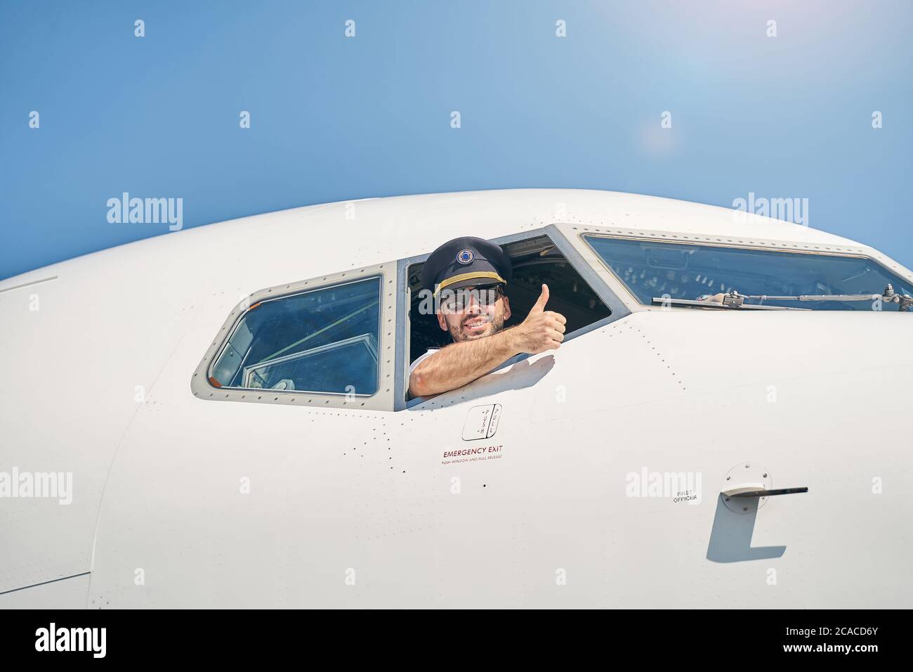 Airline pilot showing his readiness for take-off Stock Photo - Alamy