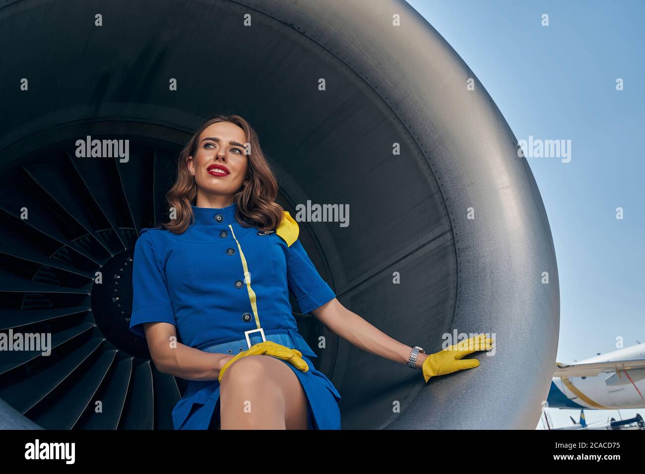 Elegant pretty lady sitting in an aircraft engine Stock Photo - Alamy