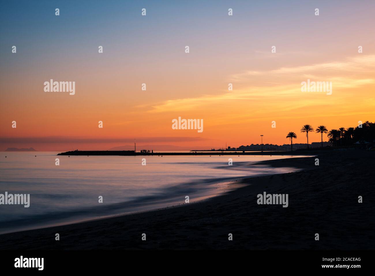 Sunset at a beach in the Costa del Sol in Marbella, Spain, with the ...