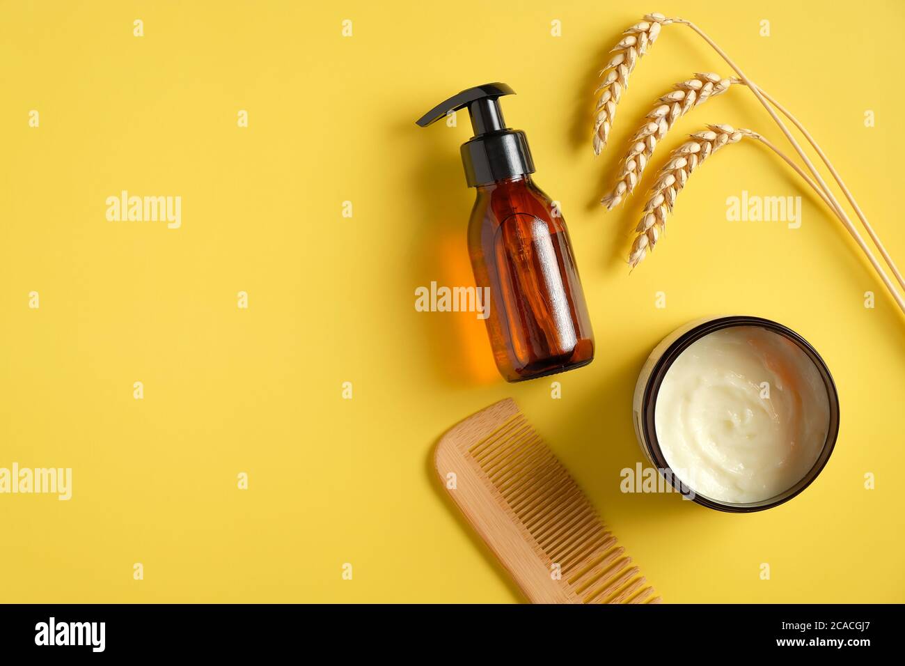 Rice, wheat, barley and oat shower gel, moisturizer cream, hair comb on ...