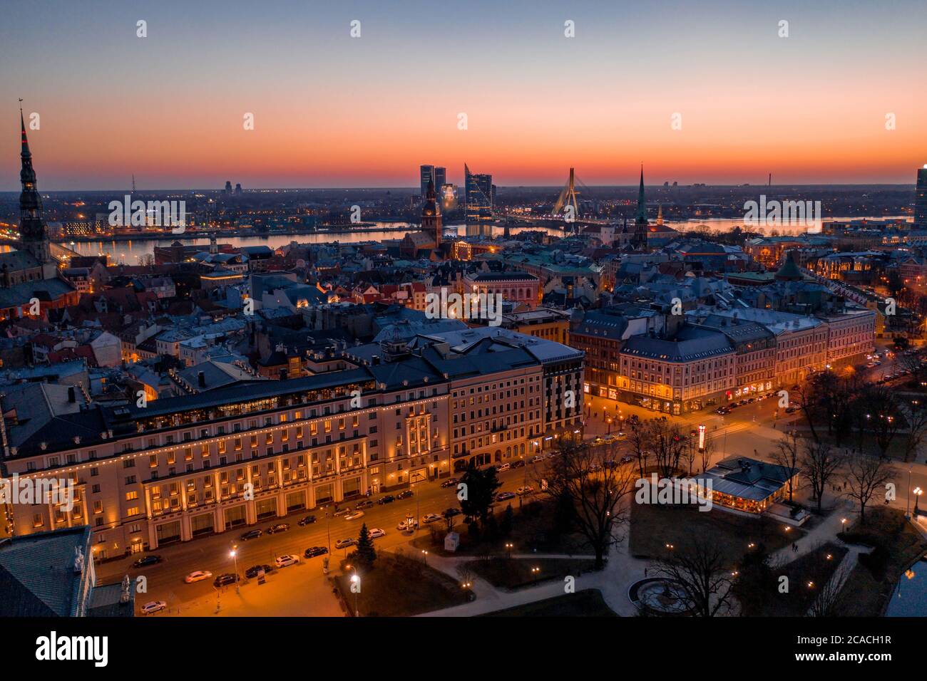 Aerial view of lovely Riga during beautiful twilight sunset with street ...