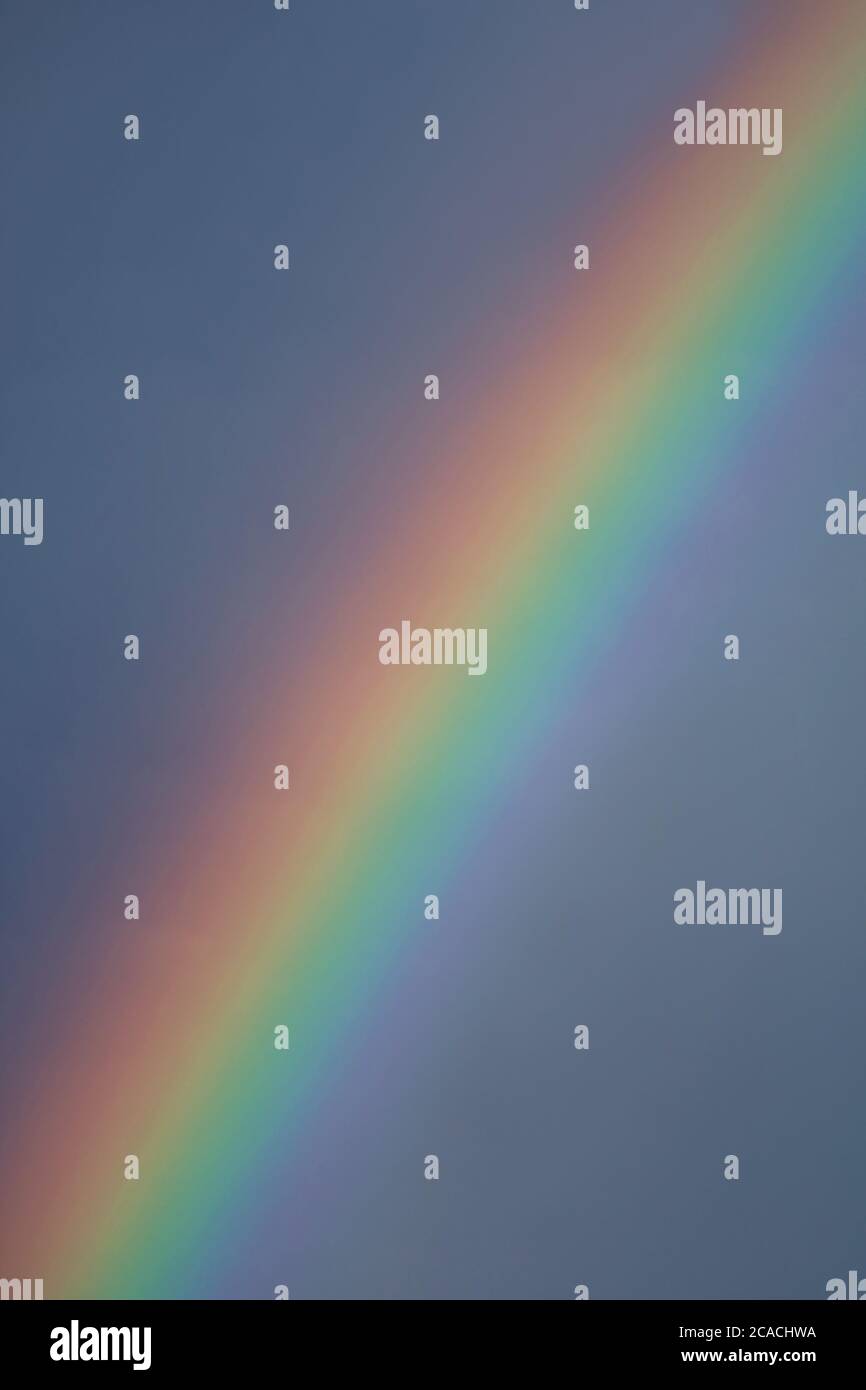 Vertical image of gorgeous rainbow in the sky Stock Photo - Alamy