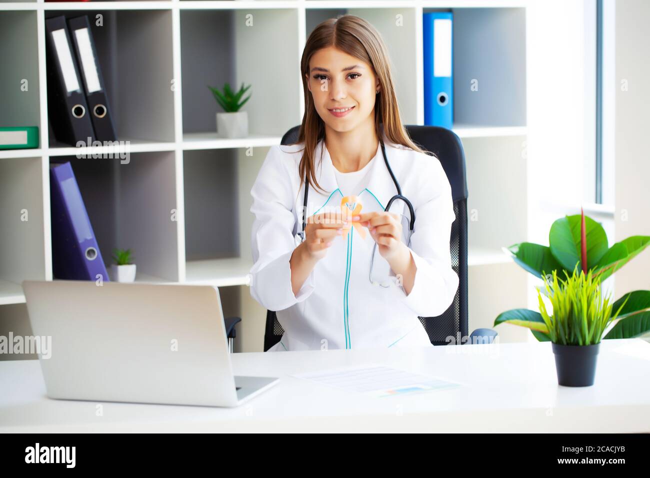 Yellow ribbon symbolic color for Sarcoma Bone cancer Stock Photo - Alamy