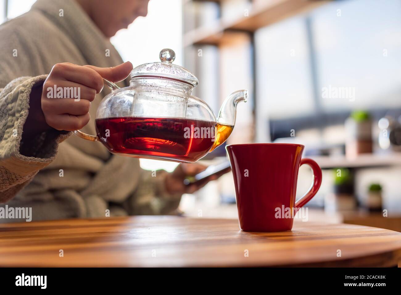 Woman serving hot tea hi-res stock photography and images - Alamy