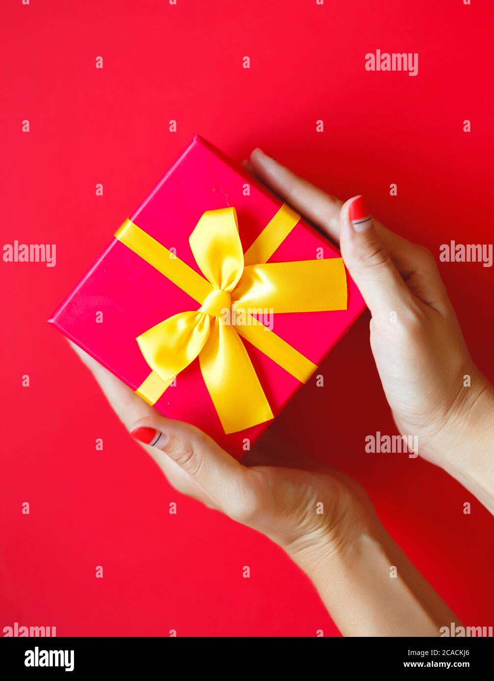 Beautiful girl hands hold gift hi-res stock photography and images - Alamy