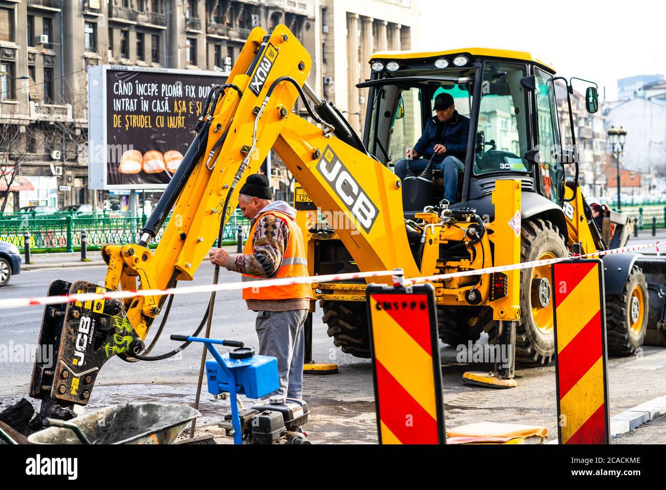 yellow backhoe loader on construction site ready for working in ...