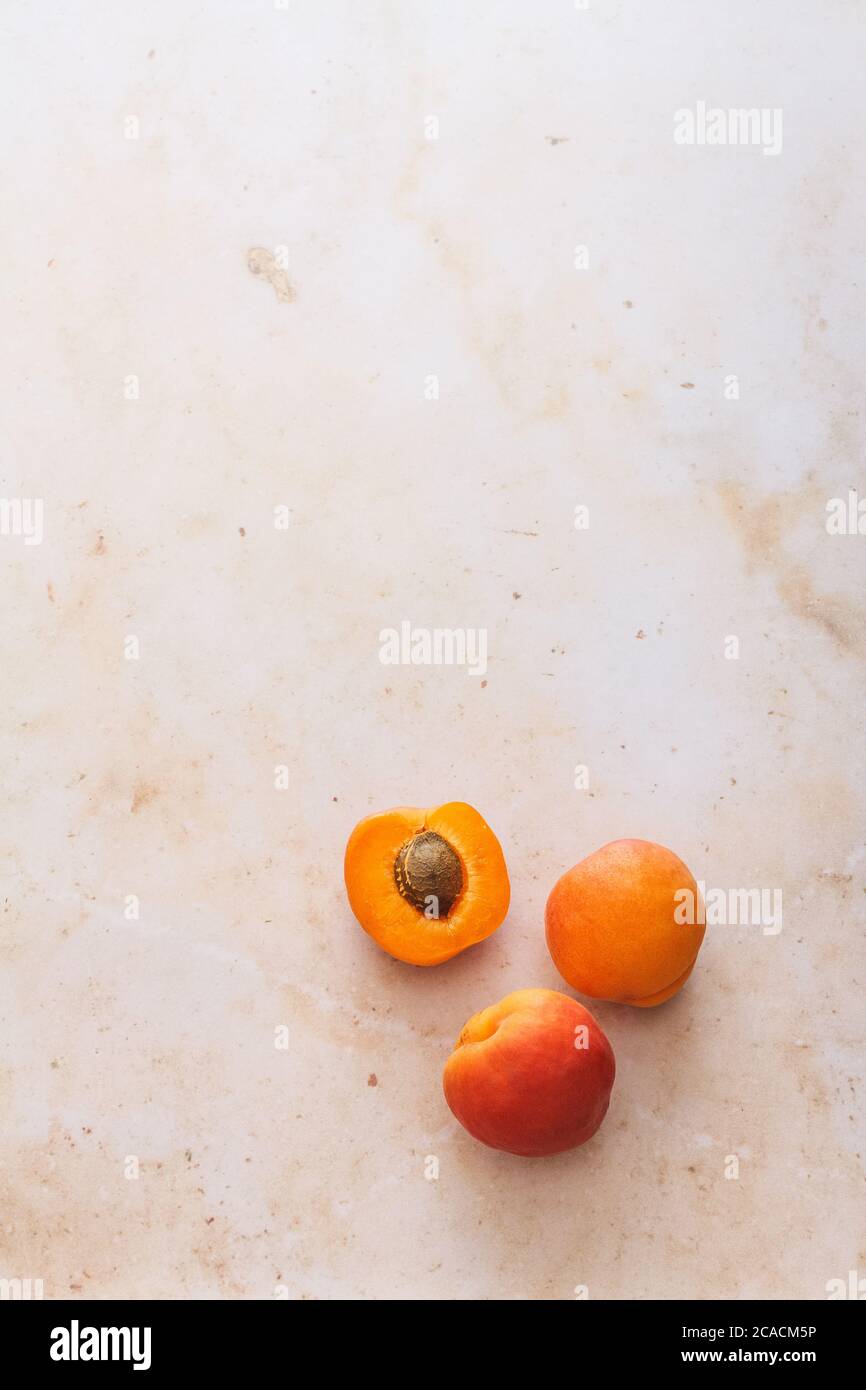 Fresh apricots from above on a pink marble backdrop Stock Photo - Alamy