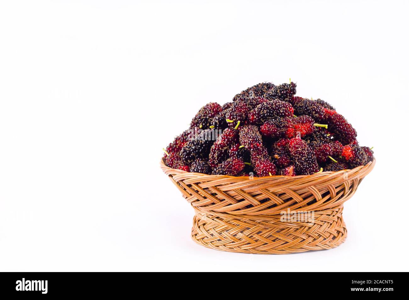 fresh organic mulberries in brown basket on white background healthy ...