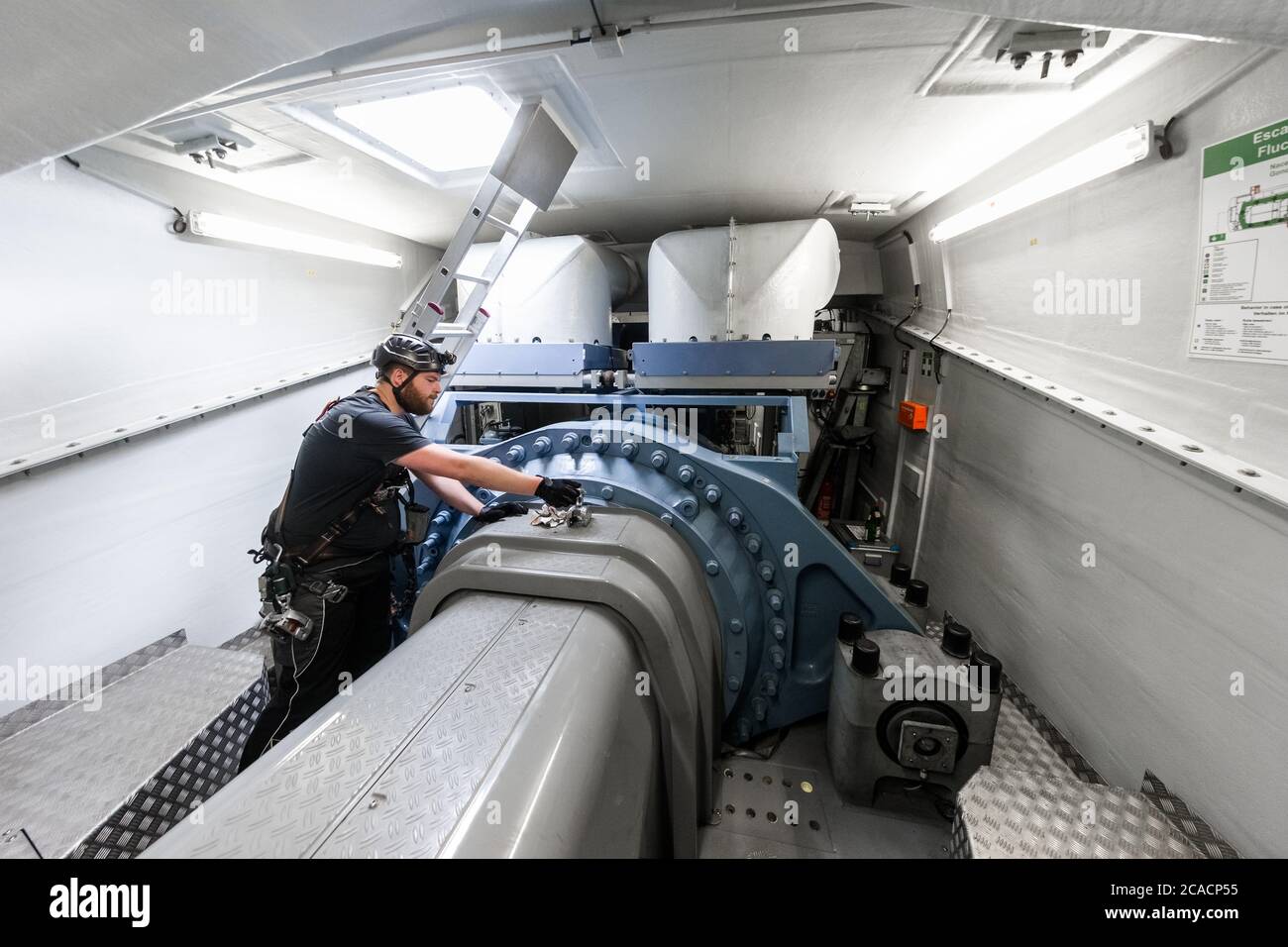 Sehestedt, Germany. 03rd Aug, 2020. A technician stands in the turbine ...