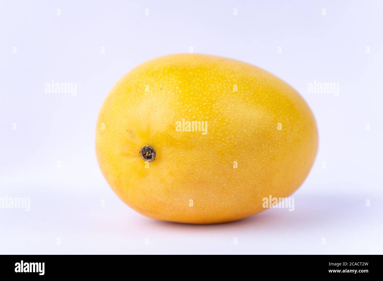Photo of ripe yellow mango on white background Stock Photo - Alamy