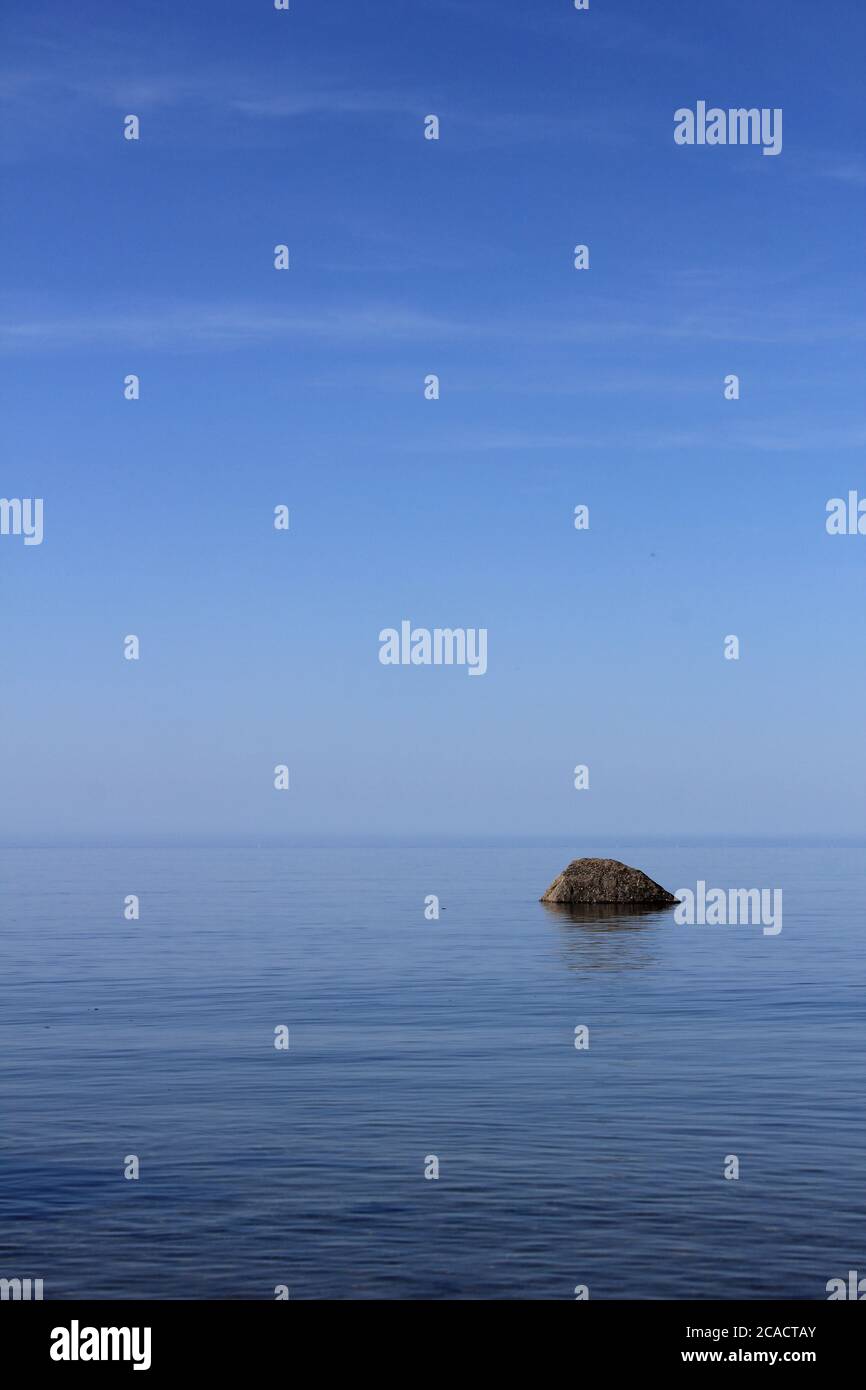 rock in calm sea Stock Photo - Alamy