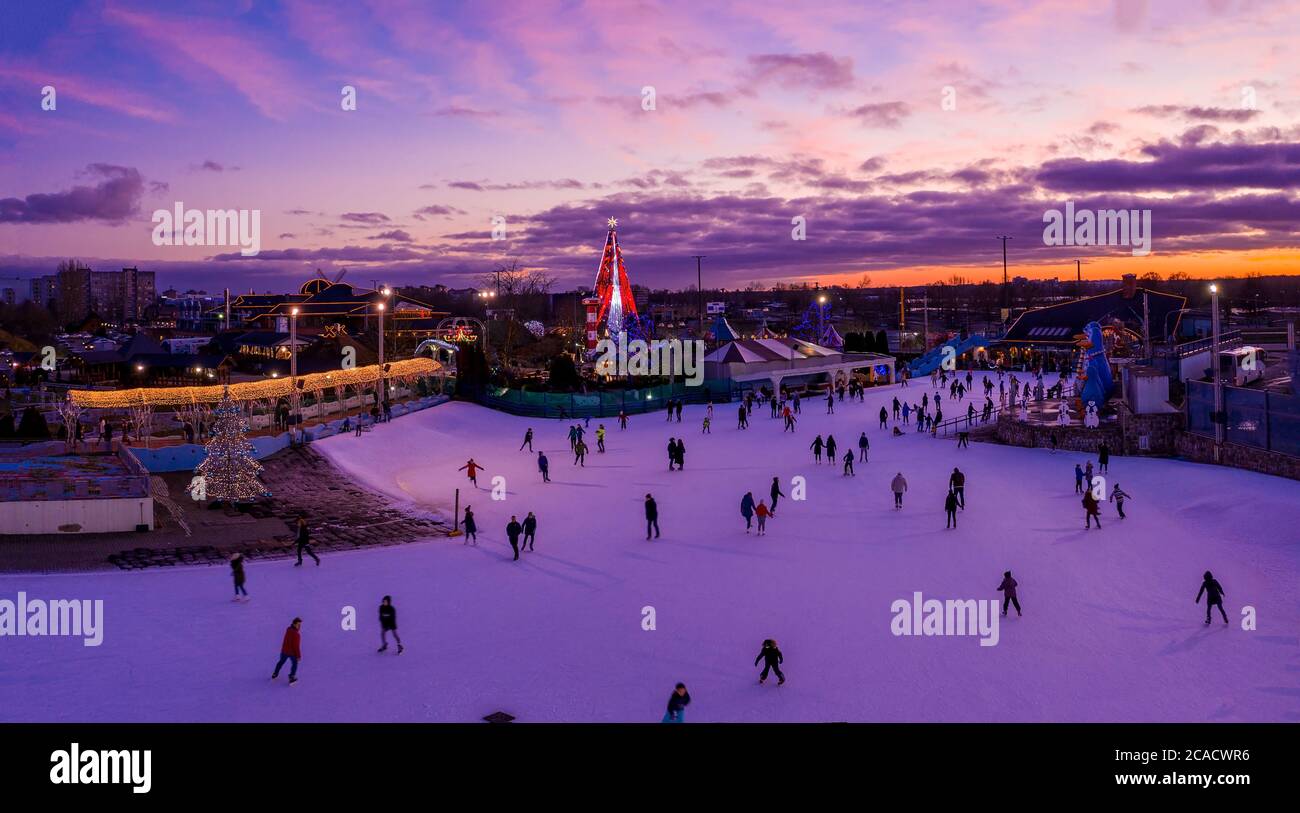 Breathtaking shot of people ice skating in the evening in Riga, Latvia ...